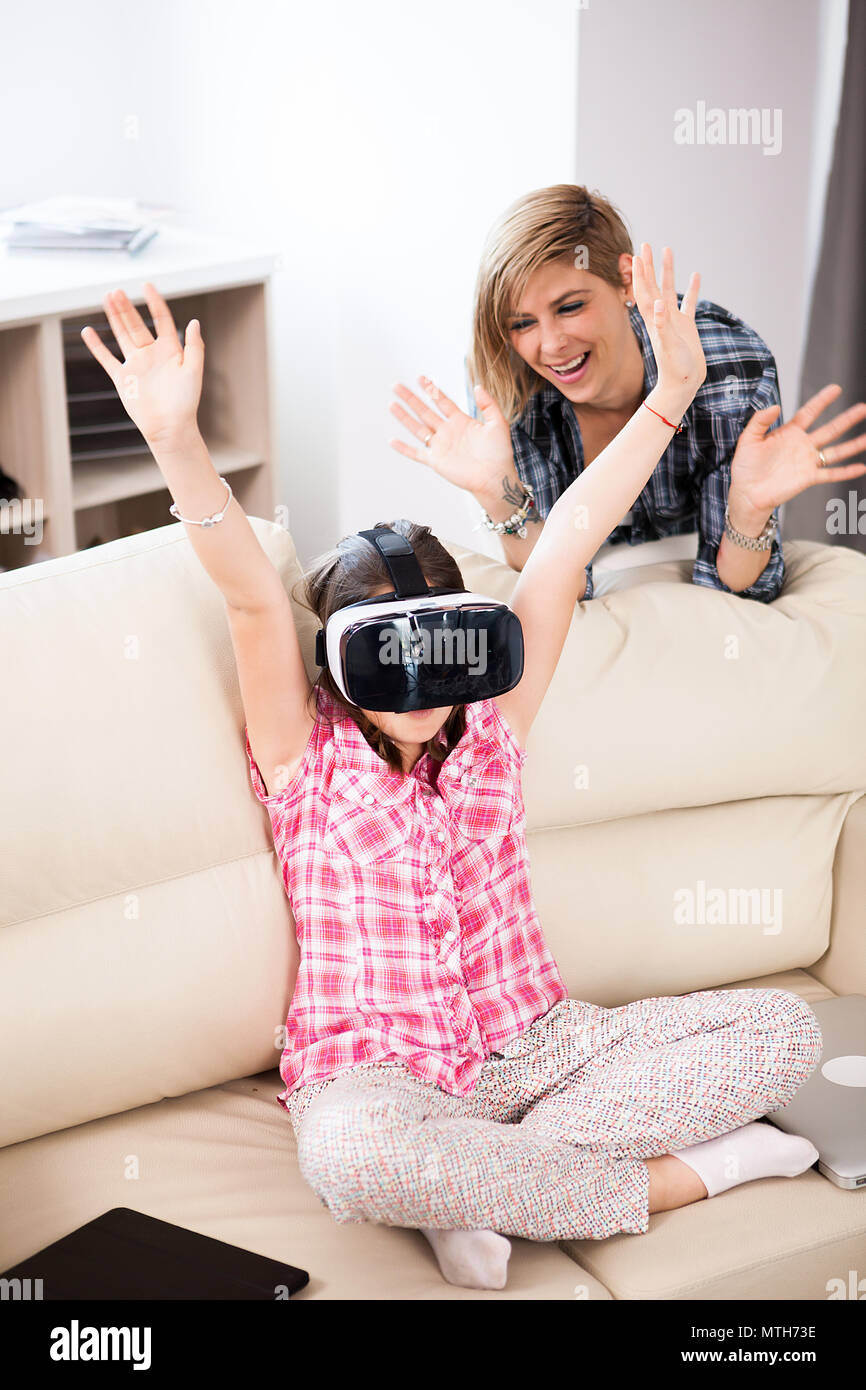 Happy kid wearing a virtual reality headset and plays games Stock Photo ...