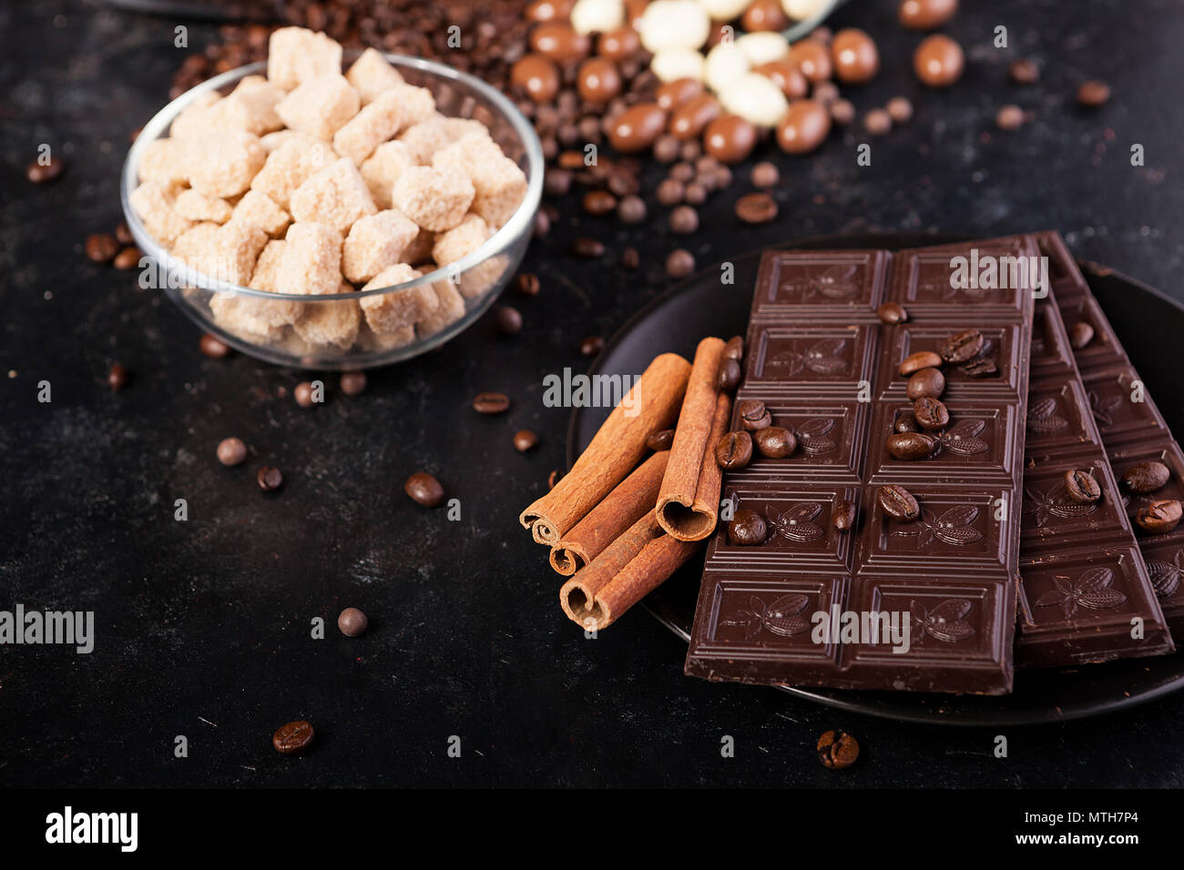 Chocolate tablets next to cinnamon rolls and other sweets and candies ...