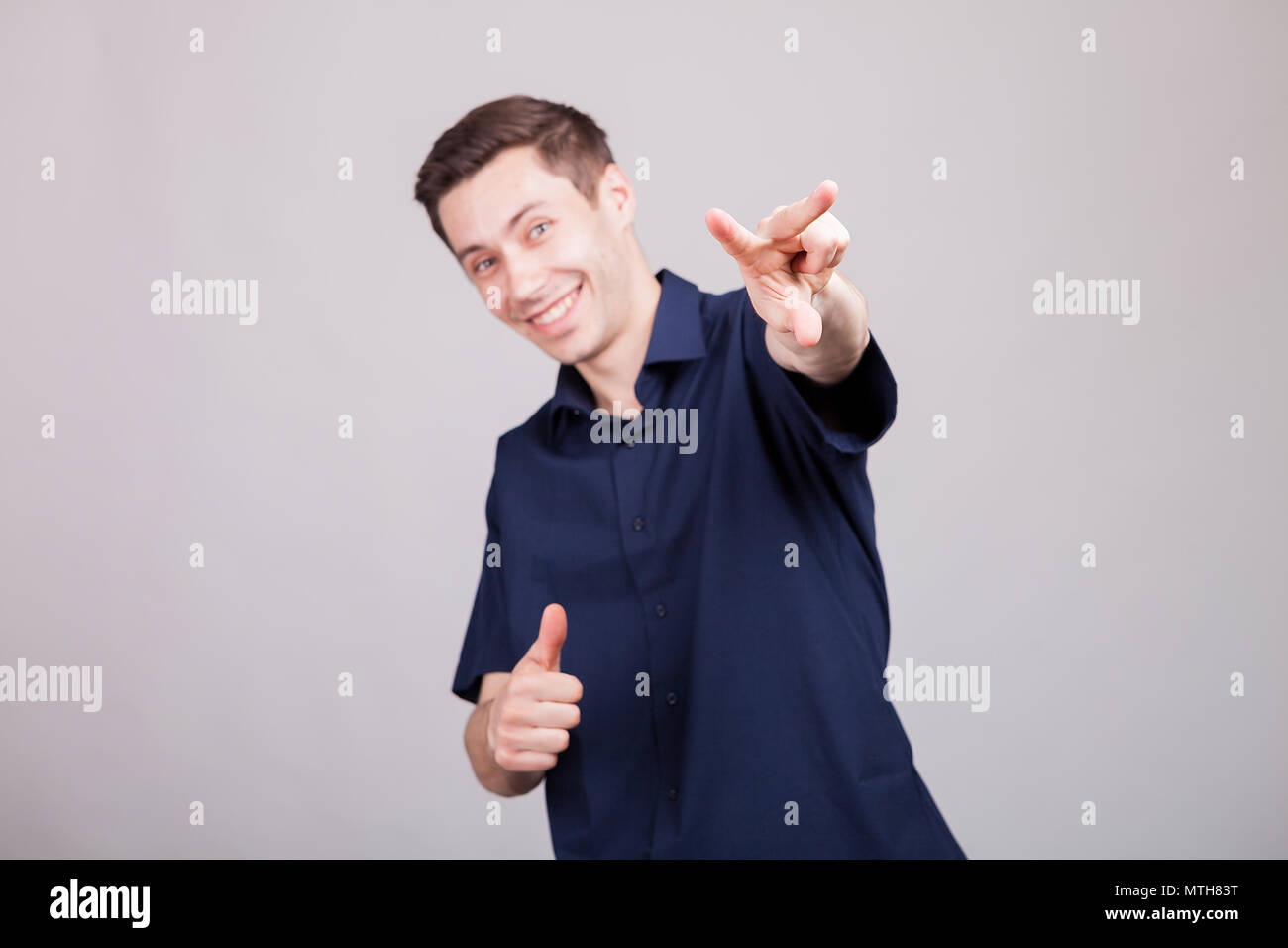 Smiling man showing peace sign hi-res stock photography and images - Alamy