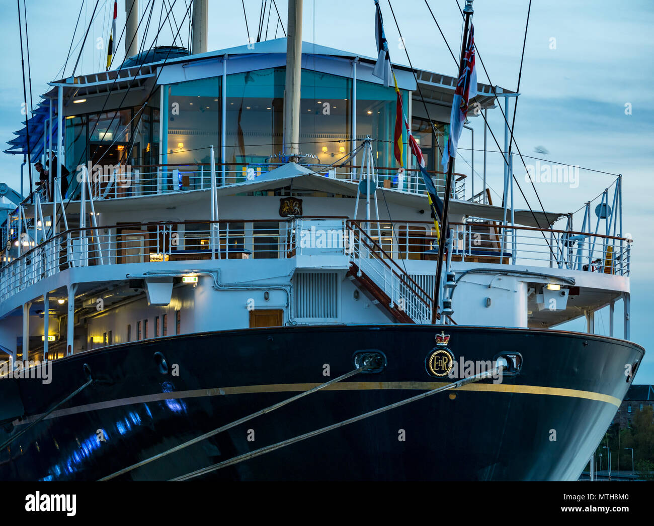 Prow of Royal Yacht Britannia ship with ER II emblem insignia at dusk ...