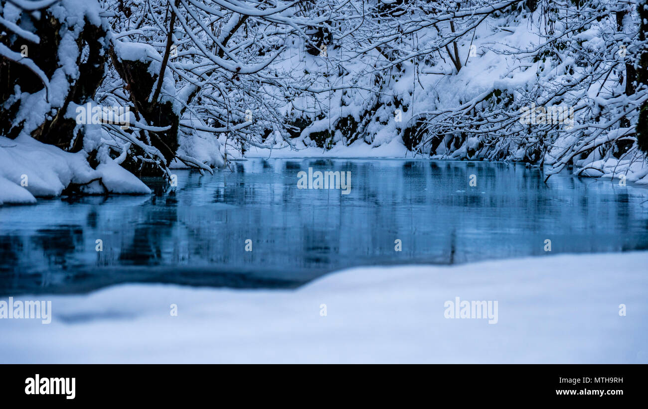 frozen stream really blue water snow winter Stock Photo - Alamy