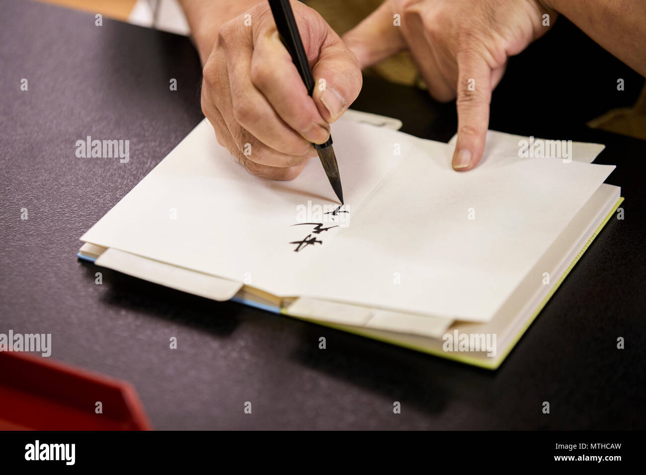 Japanese priest writing calligraphy Stock Photo - Alamy