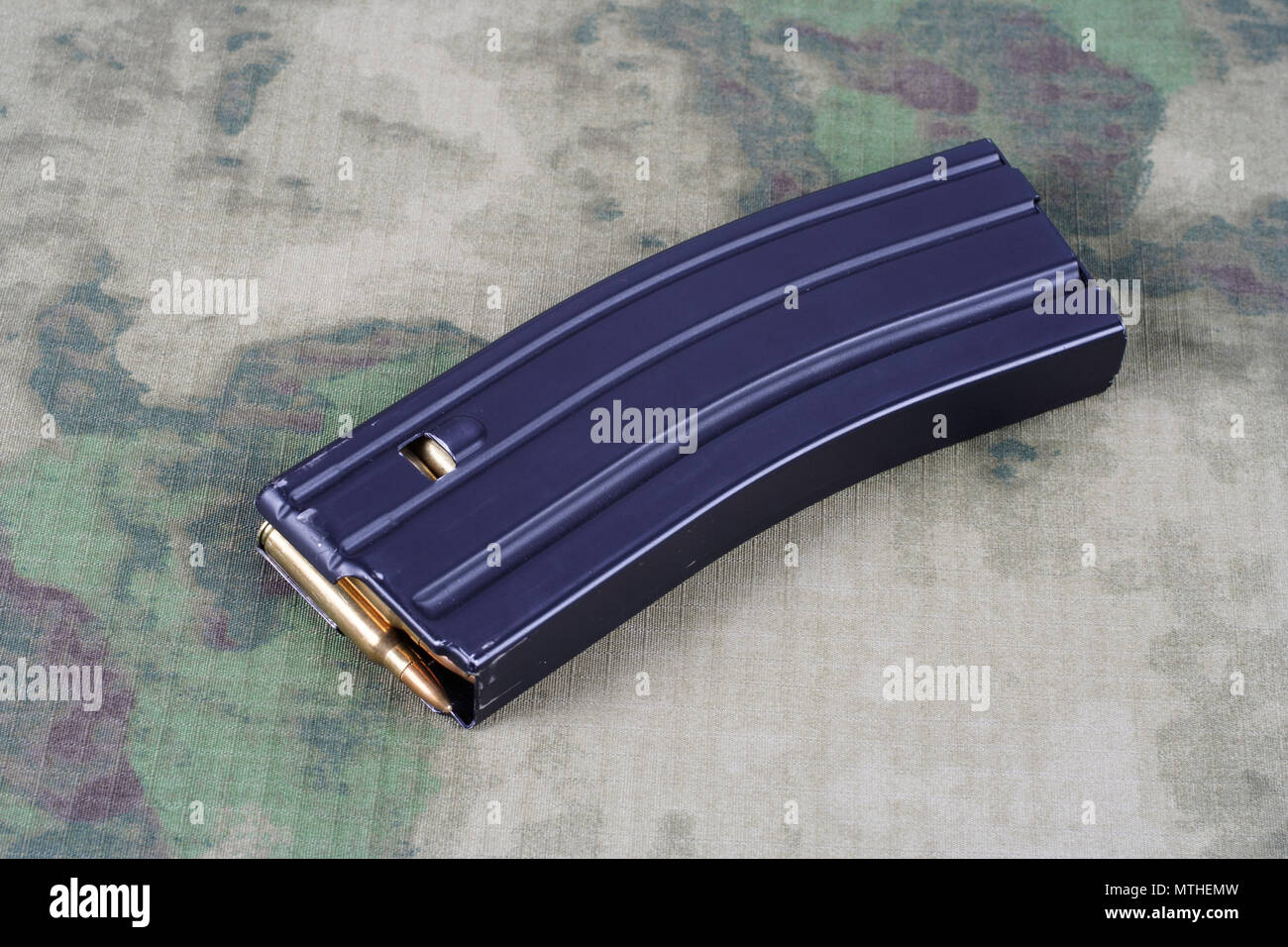 M-16 magazine with cartridges on camouflage uniform background Stock ...