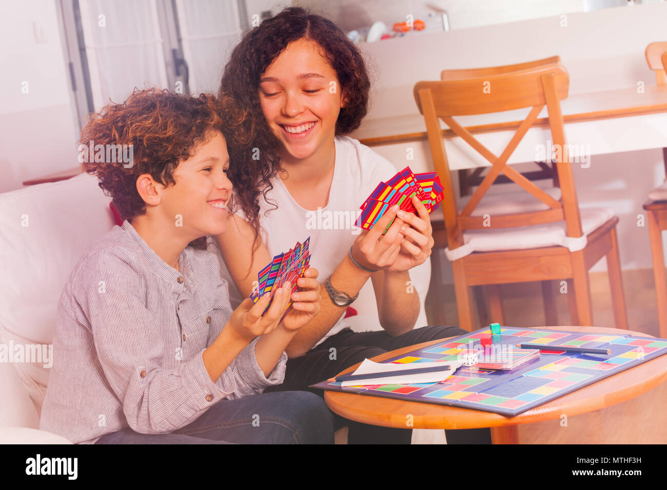 Brother sister playing cards hi-res stock photography and images - Alamy