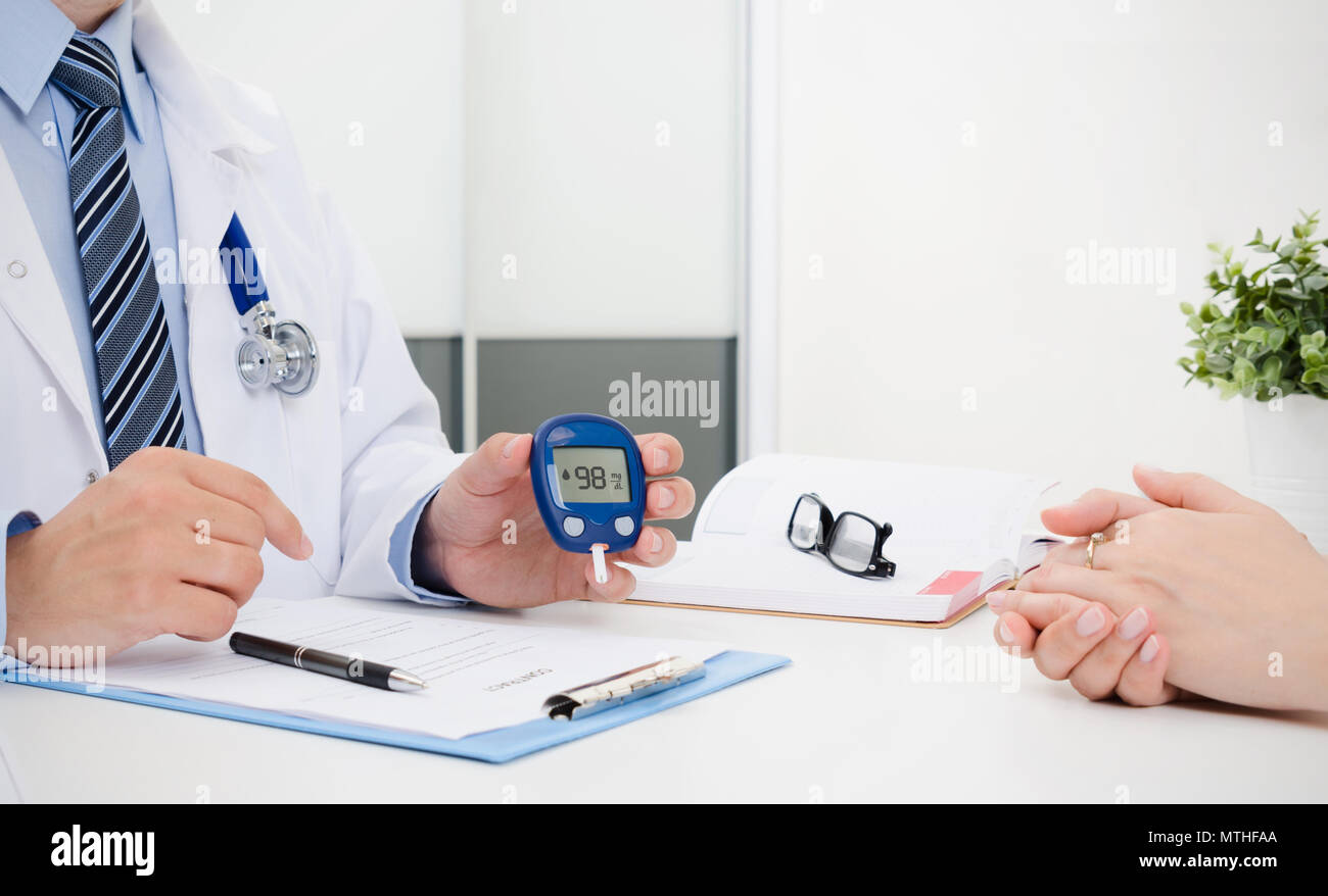 Doctor shows glucometer with glucose level. Doctor and patient diabetes ...