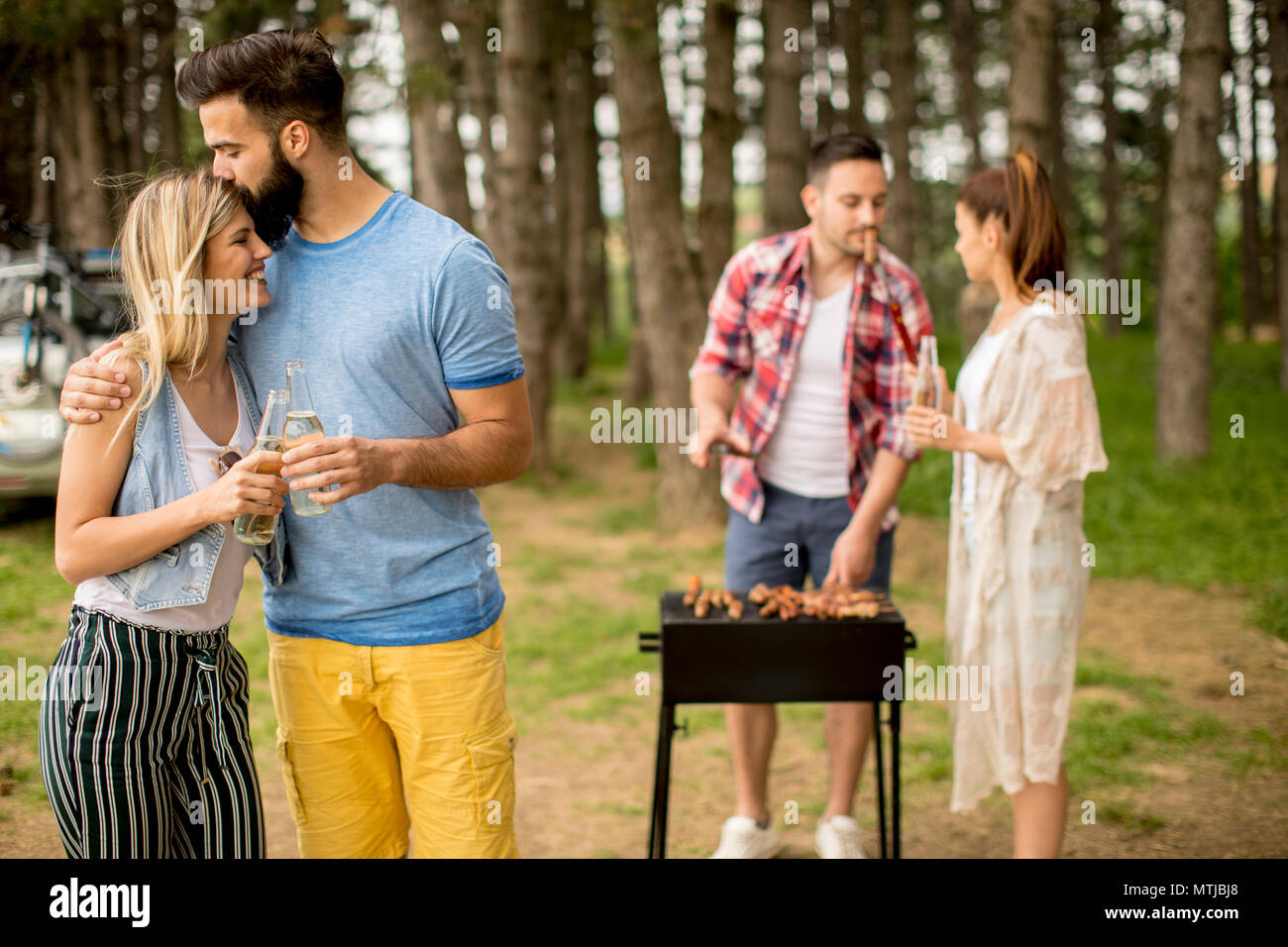 Group of young people enjoying barbecue party in the nature Stock Photo ...