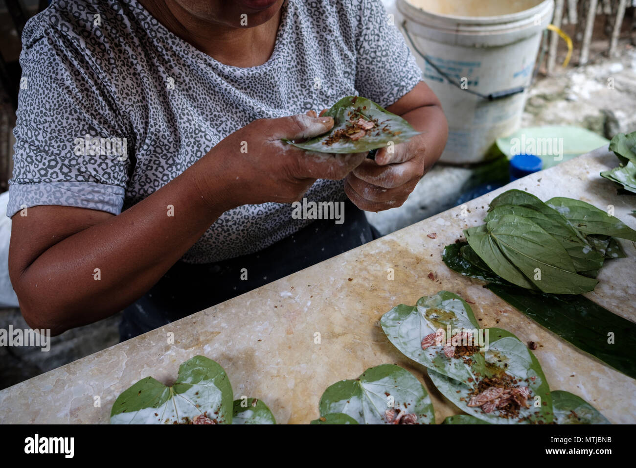 Betal Nut being prepaired for a customer by a street vendor in the 4th ...