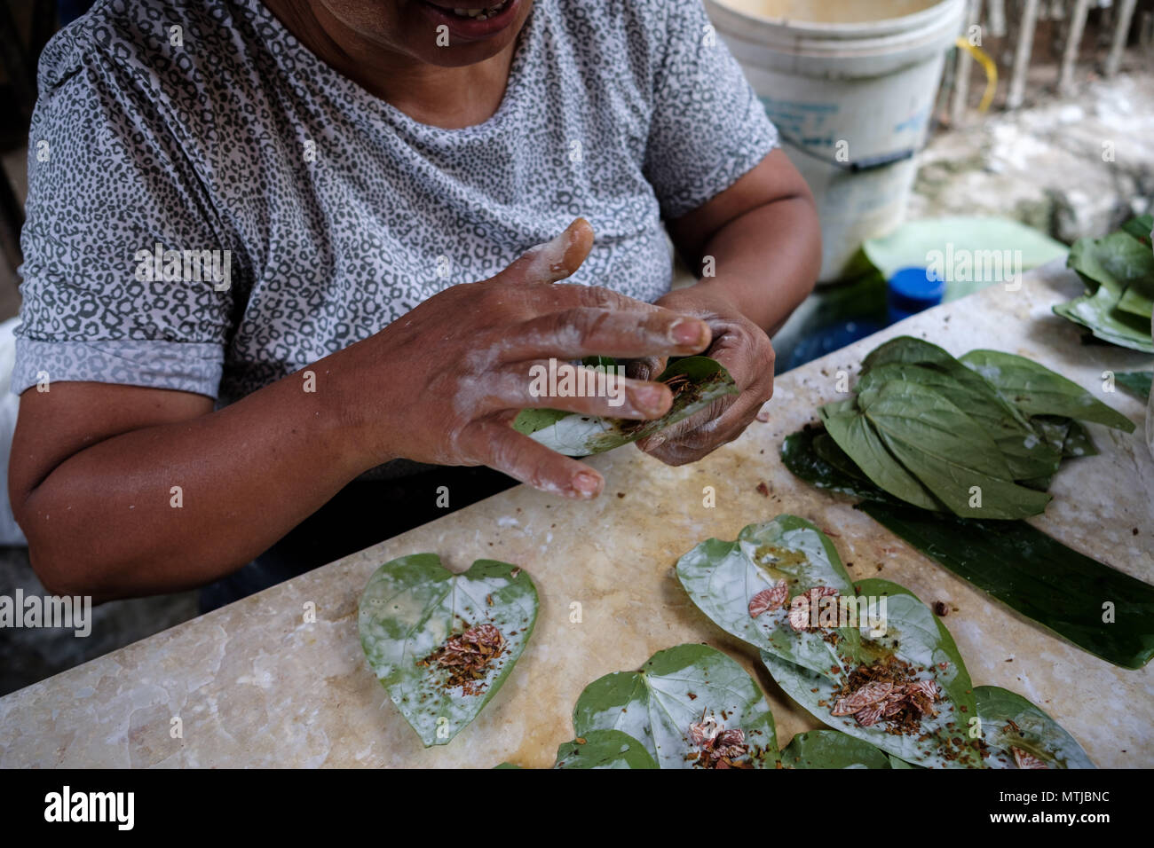 Betal Nut being prepaired for a customer by a street vendor in the 4th ...