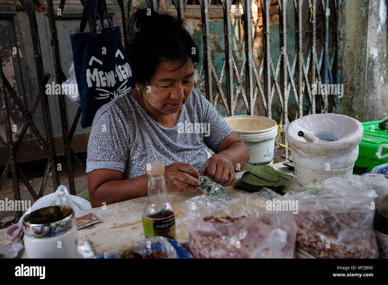Betal Nut being prepaired for a customer by a street vendor in the 4th ...