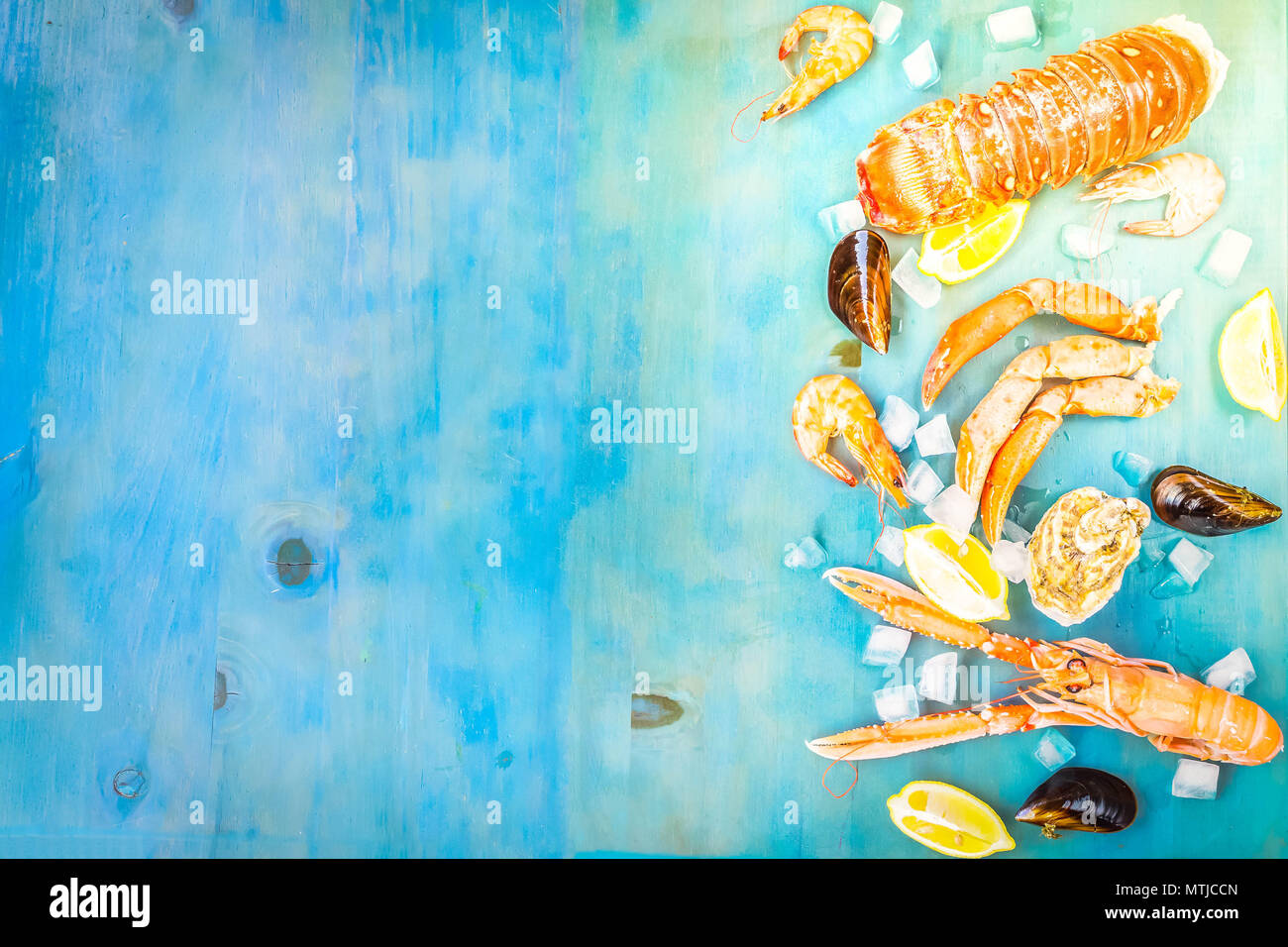 Fresh seafood border with copy space on blue background, retro toned ...