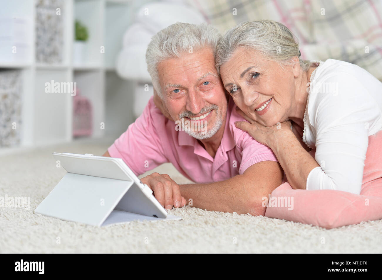 happy senior couple using tablet Stock Photo - Alamy
