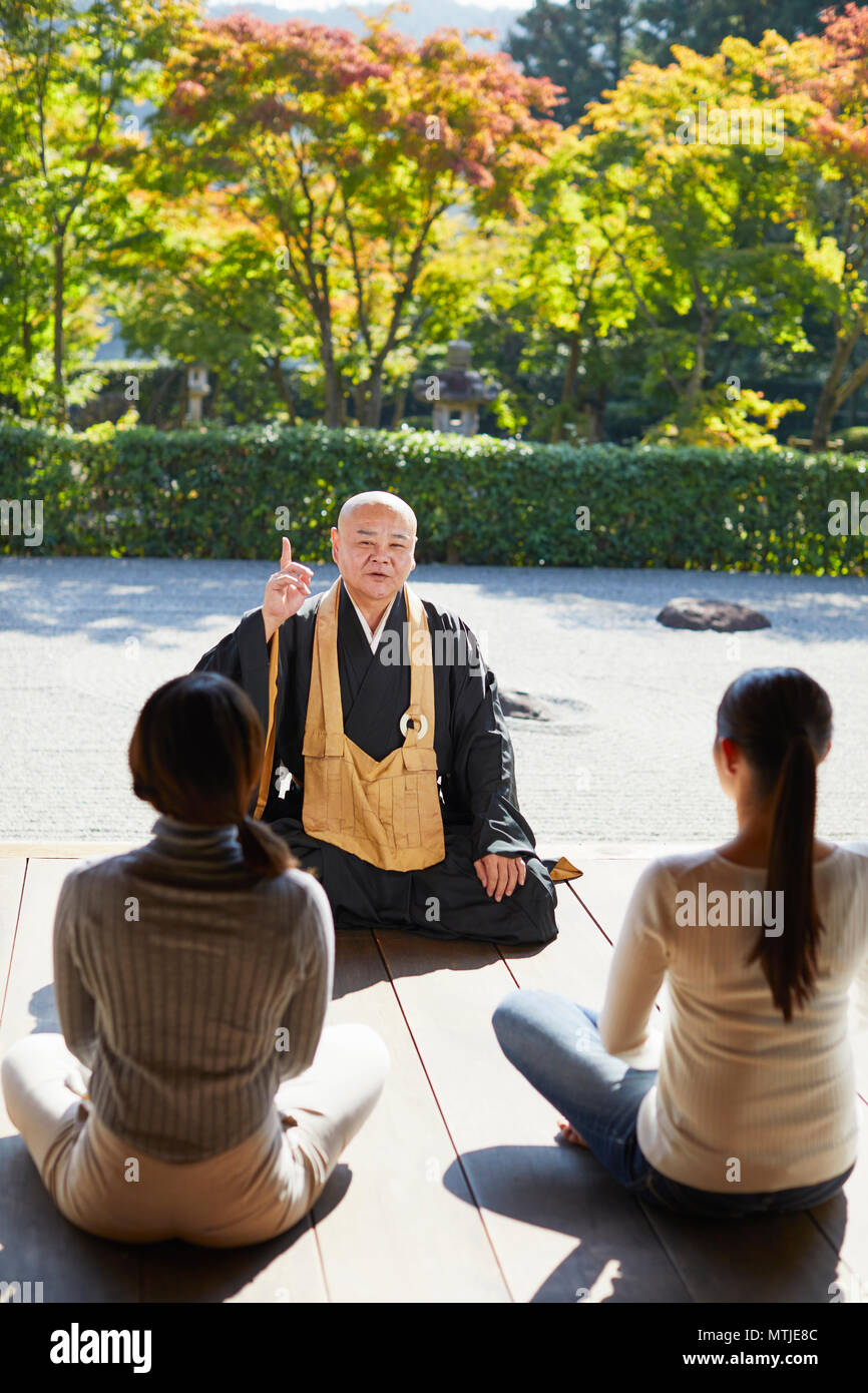 Japanese priest preaching to women at a temple Stock Photo - Alamy
