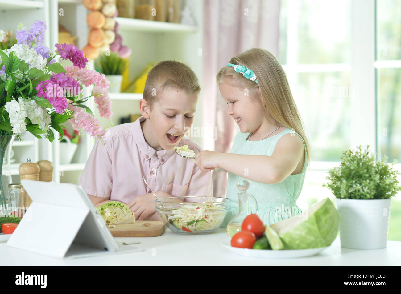 Cute little brother and sister cooking Stock Photo - Alamy