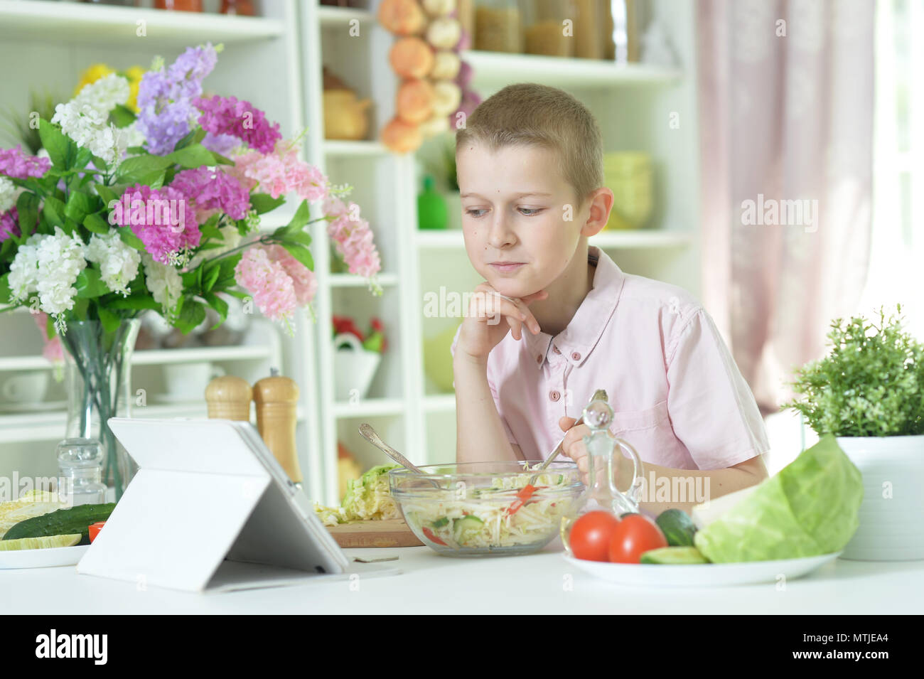 Cute little boy making dinner Stock Photo - Alamy