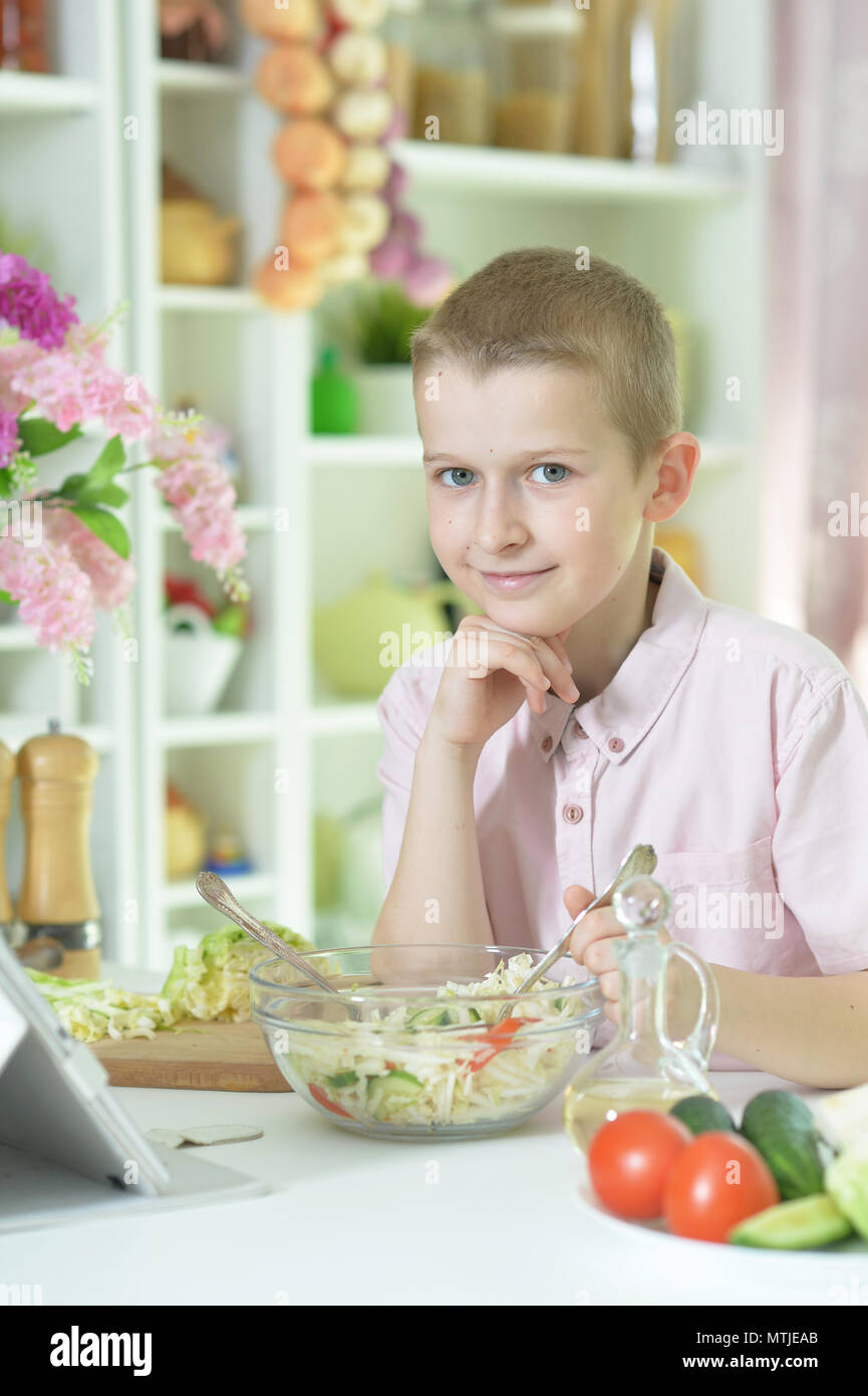 Cute little boy making dinner Stock Photo - Alamy