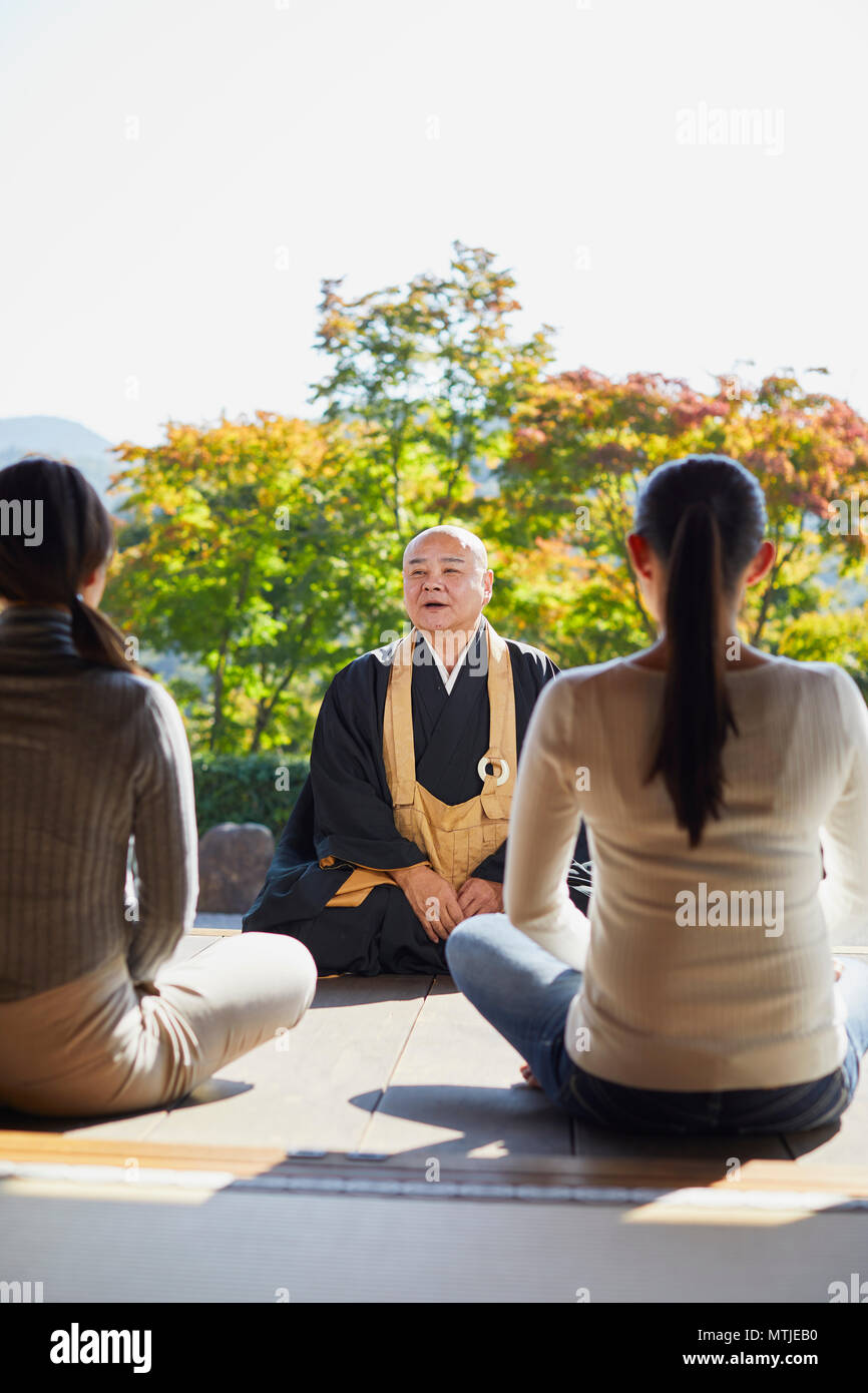 Japanese priest preaching to women at a temple Stock Photo - Alamy