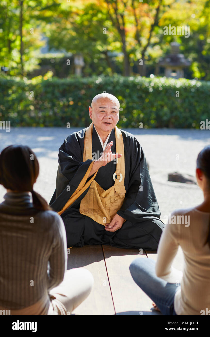 Japanese priest preaching to women at a temple Stock Photo - Alamy