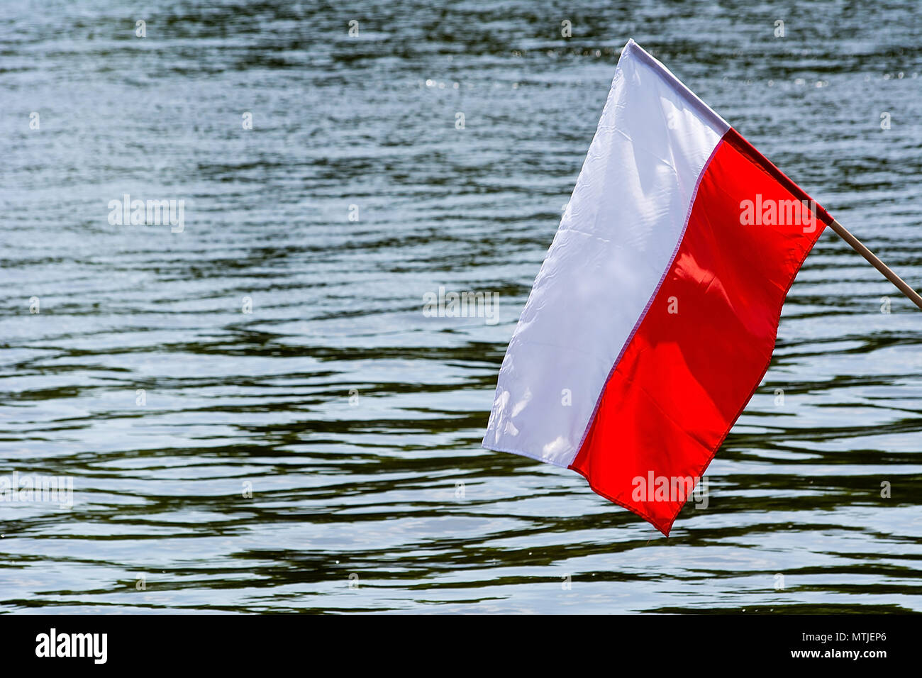 Polish flag on the water background Stock Photo - Alamy