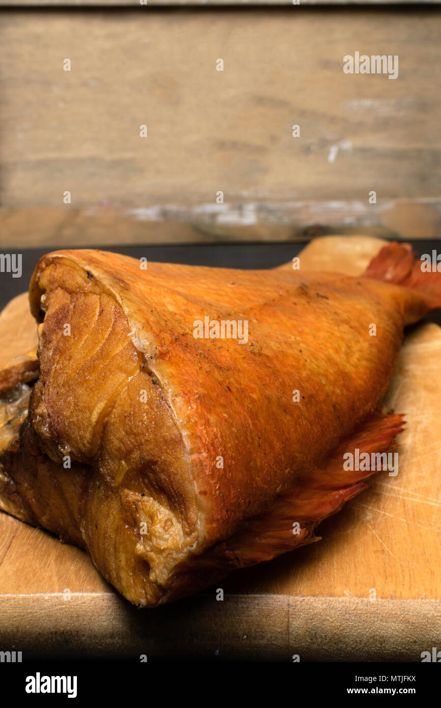 Delicious smoked fish, ocean perch, on wooden background for healthy ...