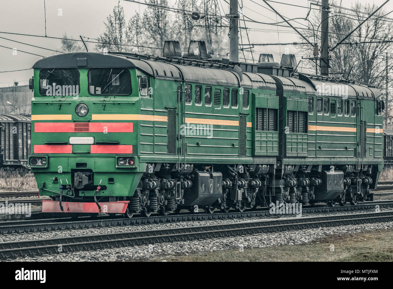 Green diesel cargo locomotive. Freight train in action Stock Photo - Alamy