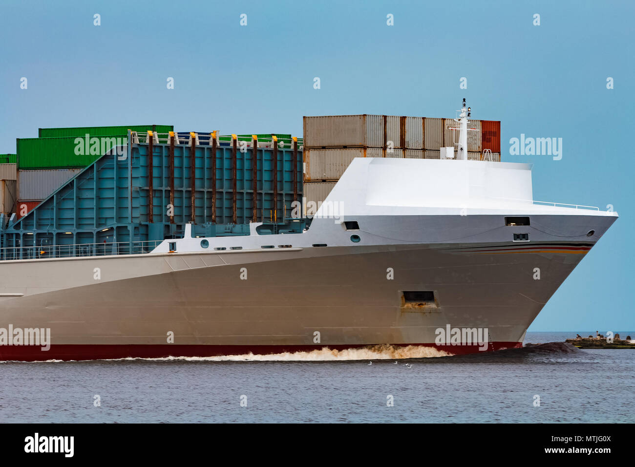 Grey container ship. Logistics and production import Stock Photo - Alamy