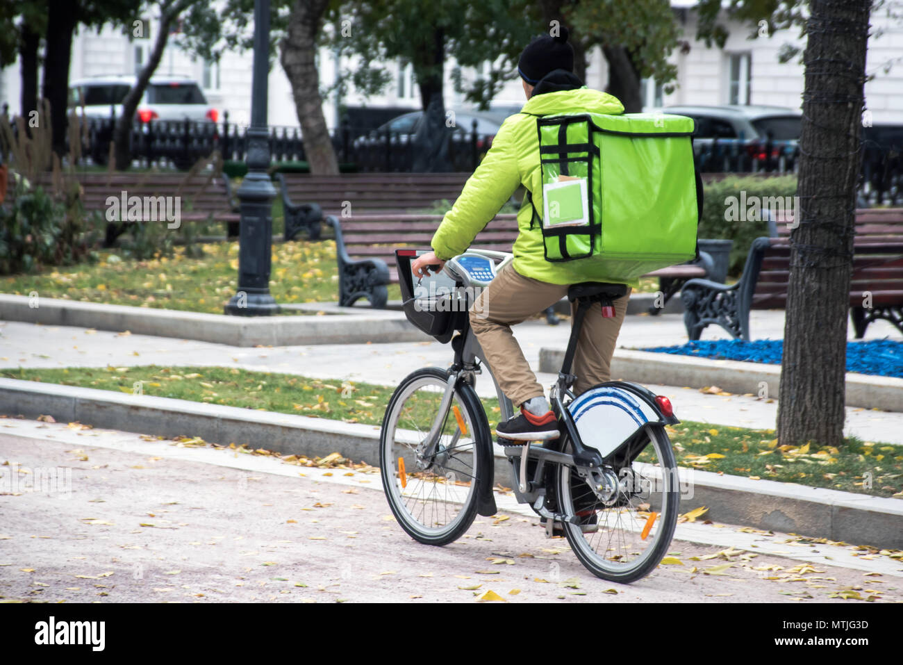 delivery man on the bike in the city roadway Stock Photo - Alamy