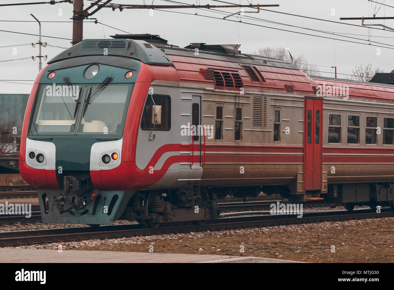 Red diesel passenger train driving at the old terminal Stock Photo - Alamy
