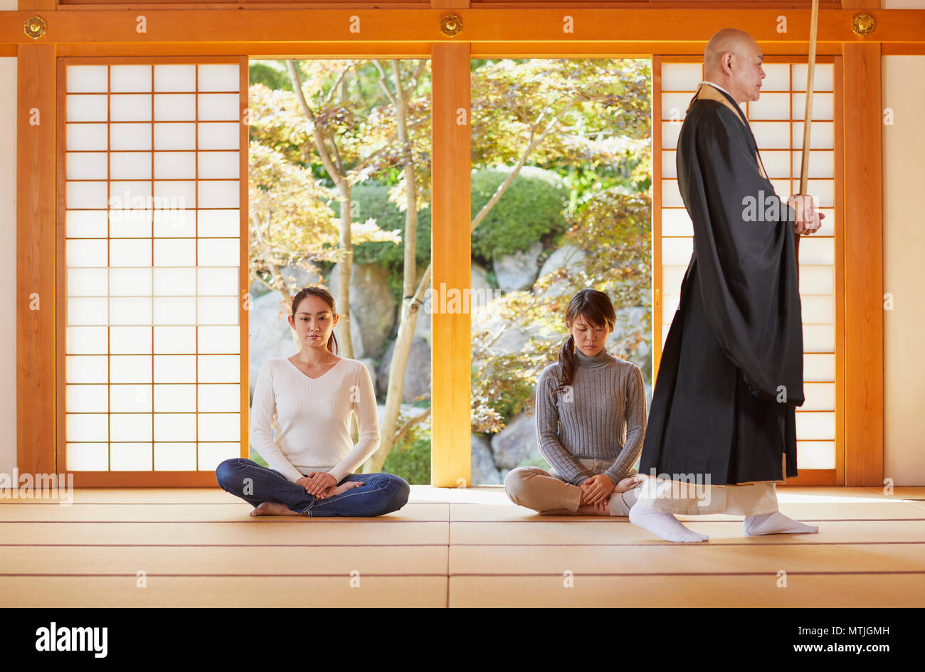 Japanese priest preaching to women at a temple Stock Photo - Alamy