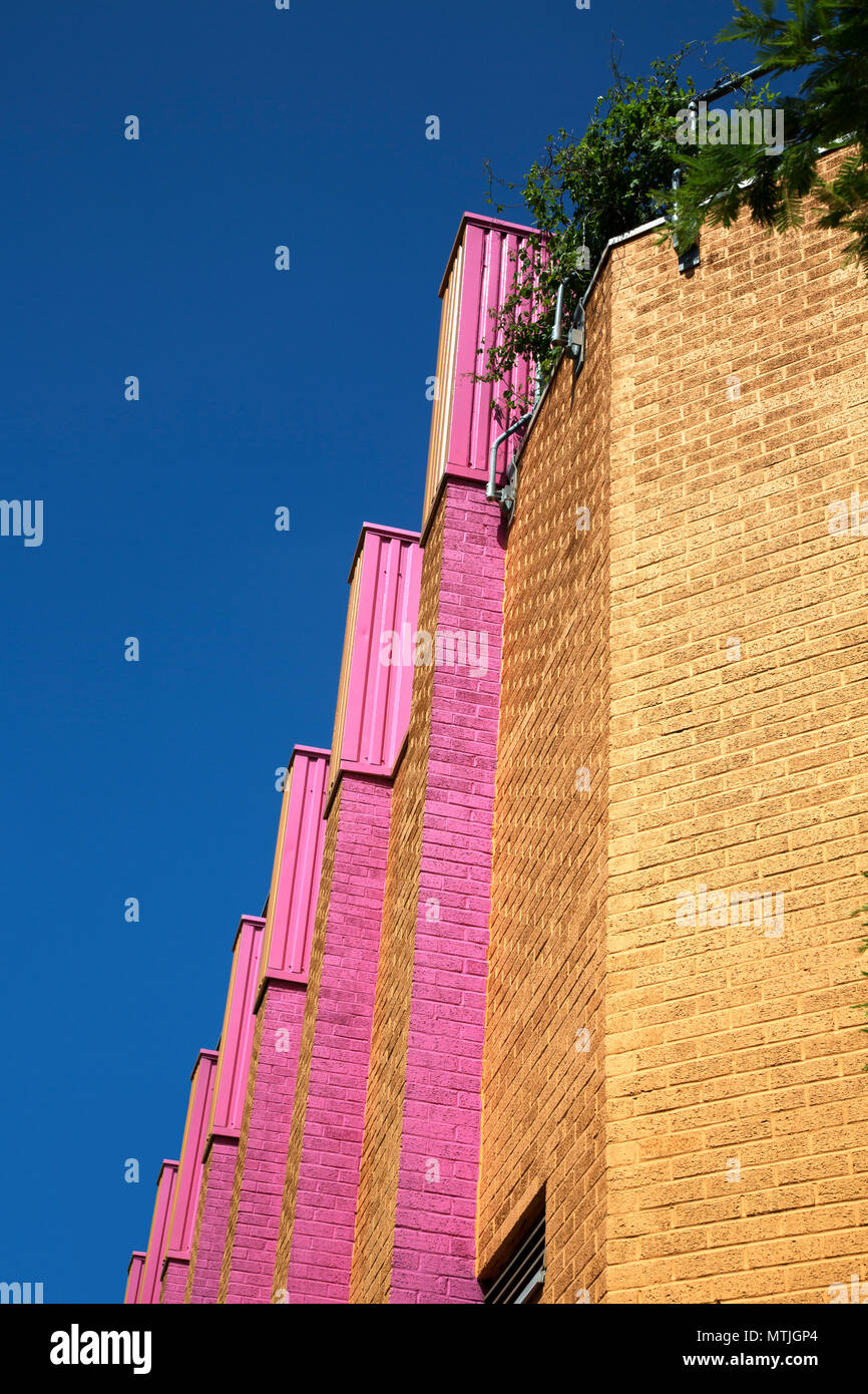 Pink and Yellow brick building and blue sky Stock Photo - Alamy