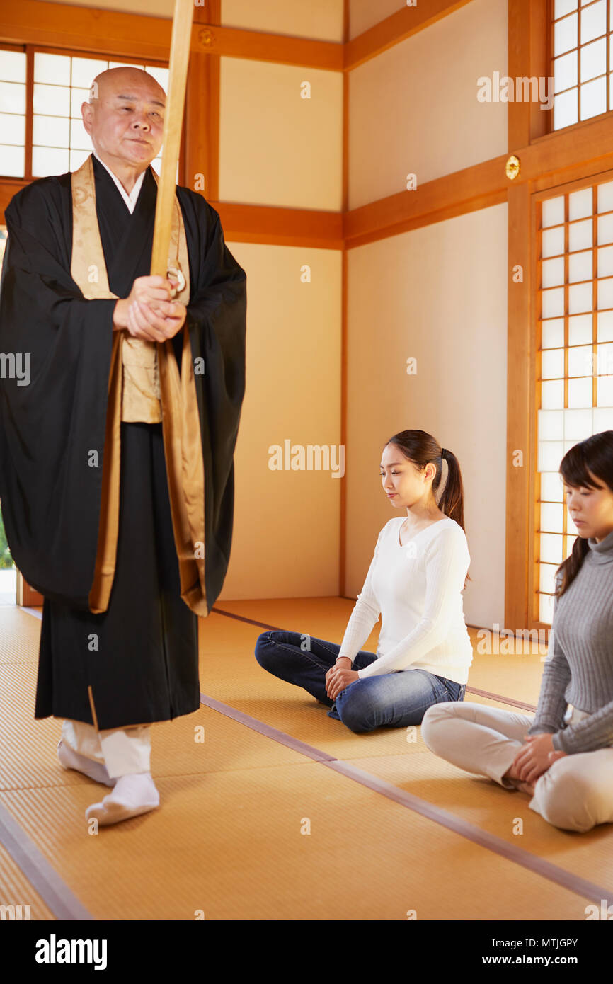 Japanese priest preaching to women at a temple Stock Photo - Alamy