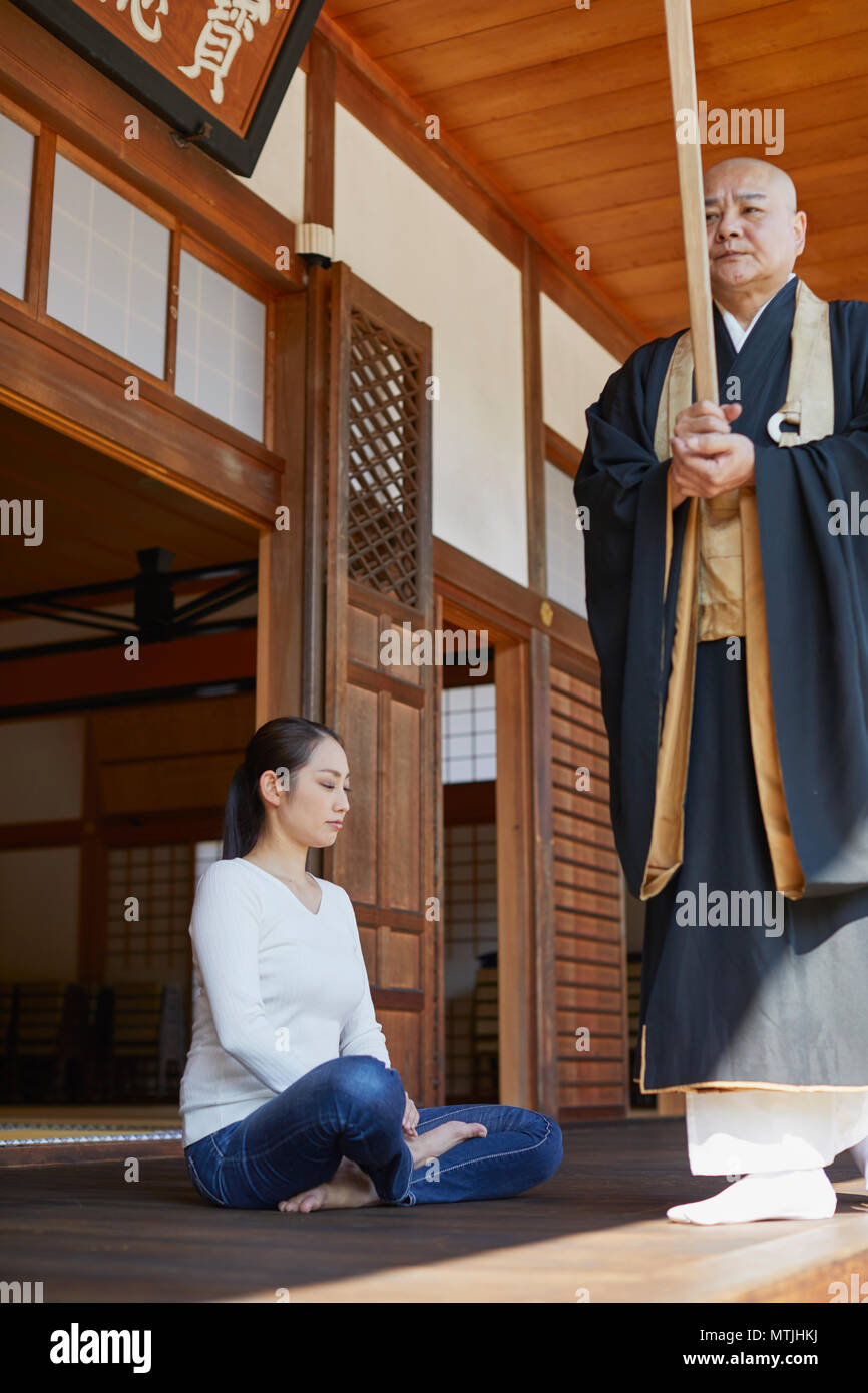 Japanese priest preaching to woman at a temple Stock Photo - Alamy