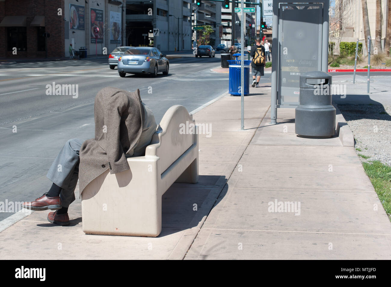 Vegas - tramp on bench with coat on head Stock Photo - Alamy
