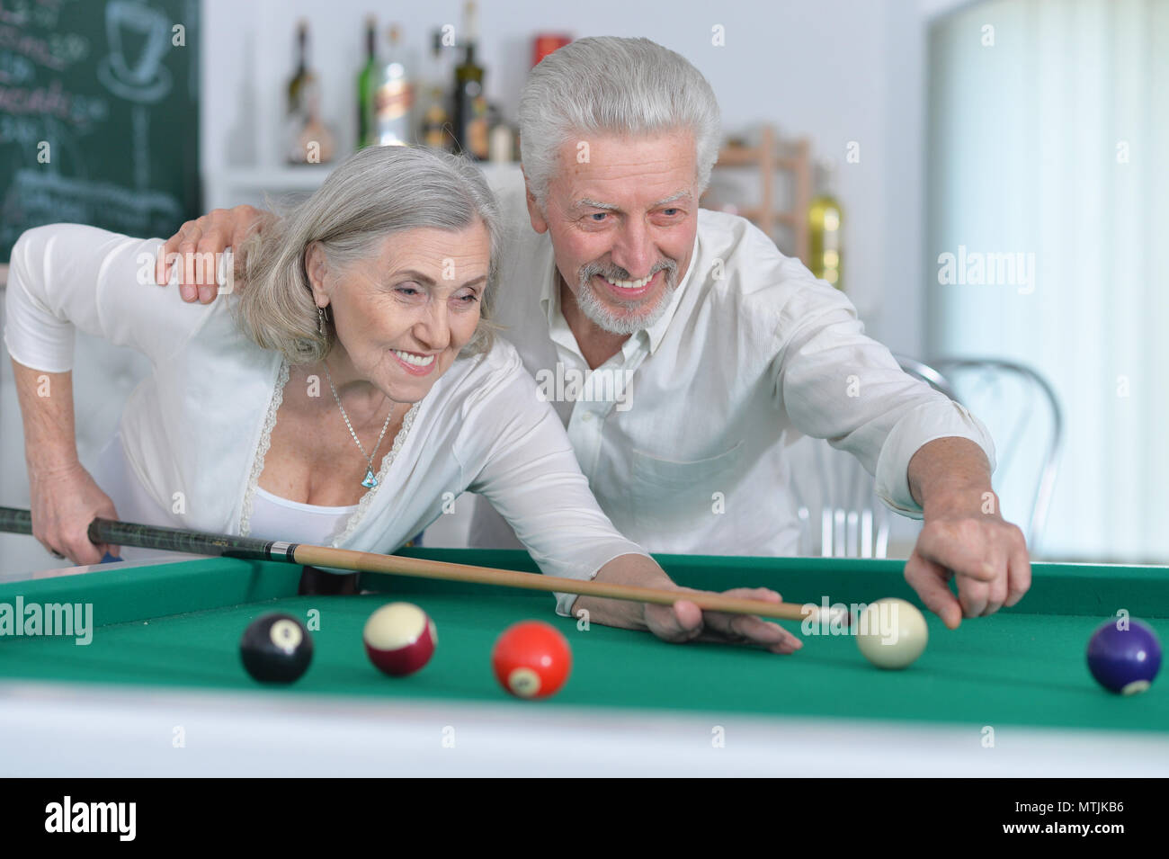 senior couple playing billiard Stock Photo - Alamy
