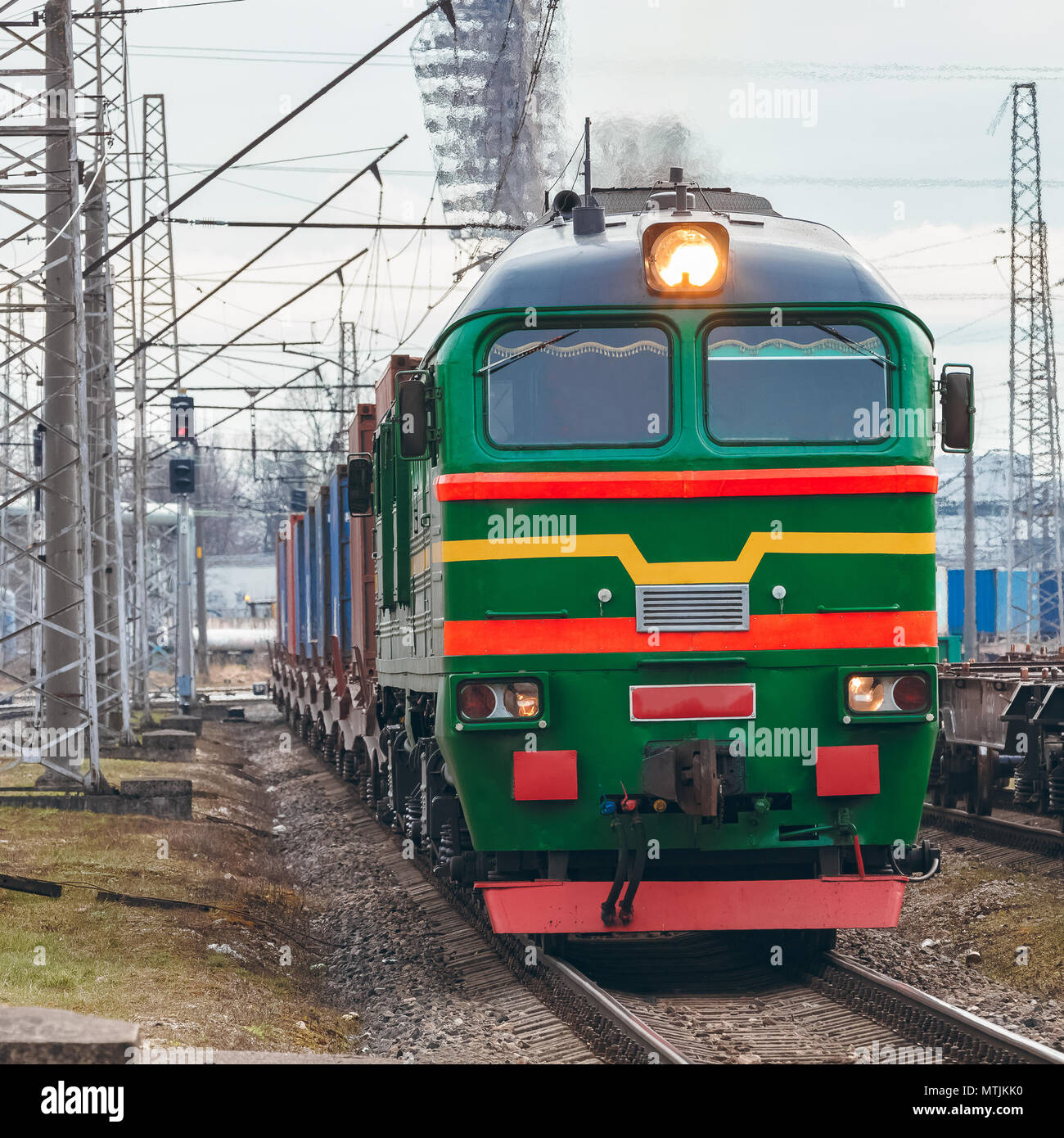Green diesel cargo locomotive. Freight train in action Stock Photo - Alamy