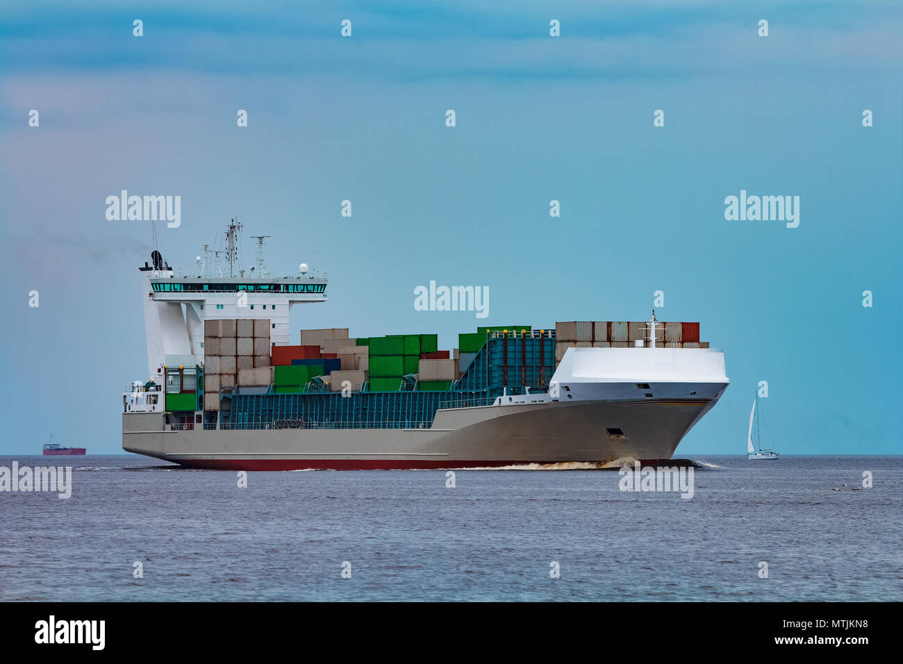 Grey container ship. Logistics and production import Stock Photo - Alamy