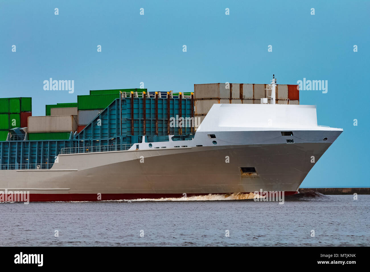 Grey container ship. Logistics and production import Stock Photo - Alamy