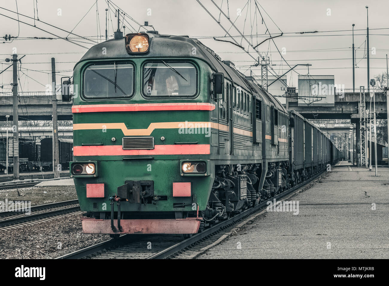 Green diesel cargo locomotive. Freight train in action Stock Photo - Alamy
