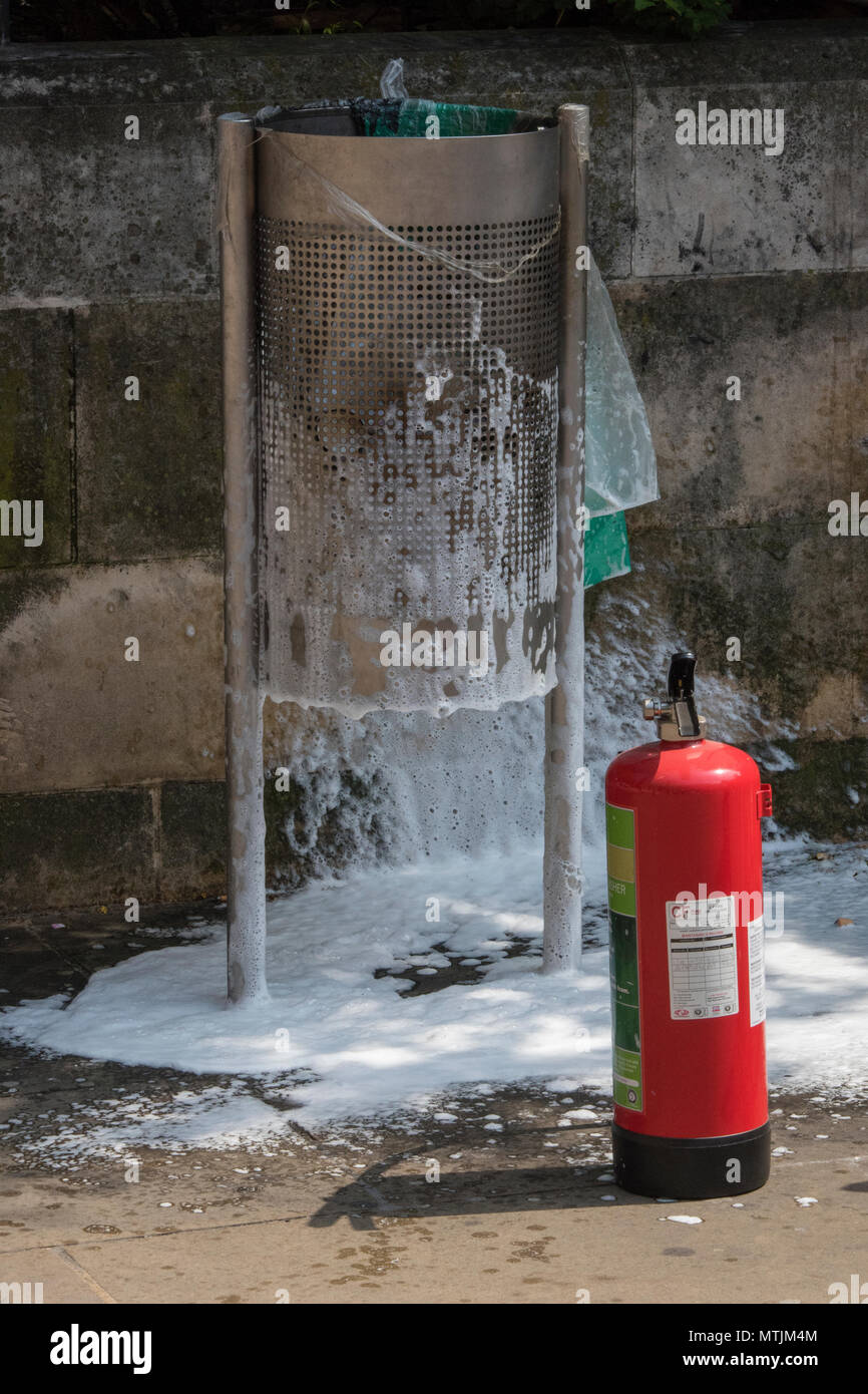 a fire in a waste paper bin or litter bin at the side of the road ...