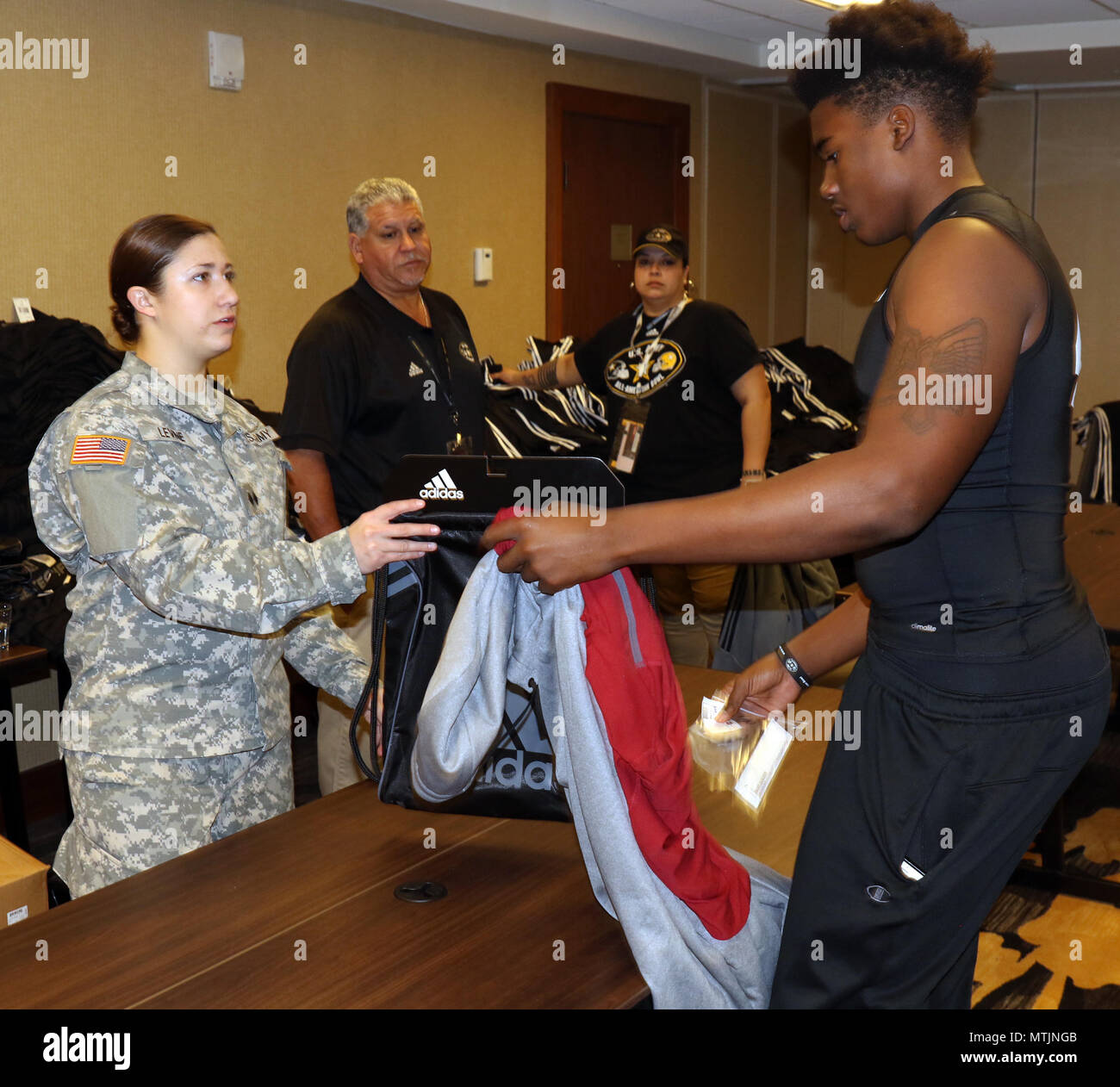 Cadet Hannah Levine, Penn State, hands out gear to one of the players ...