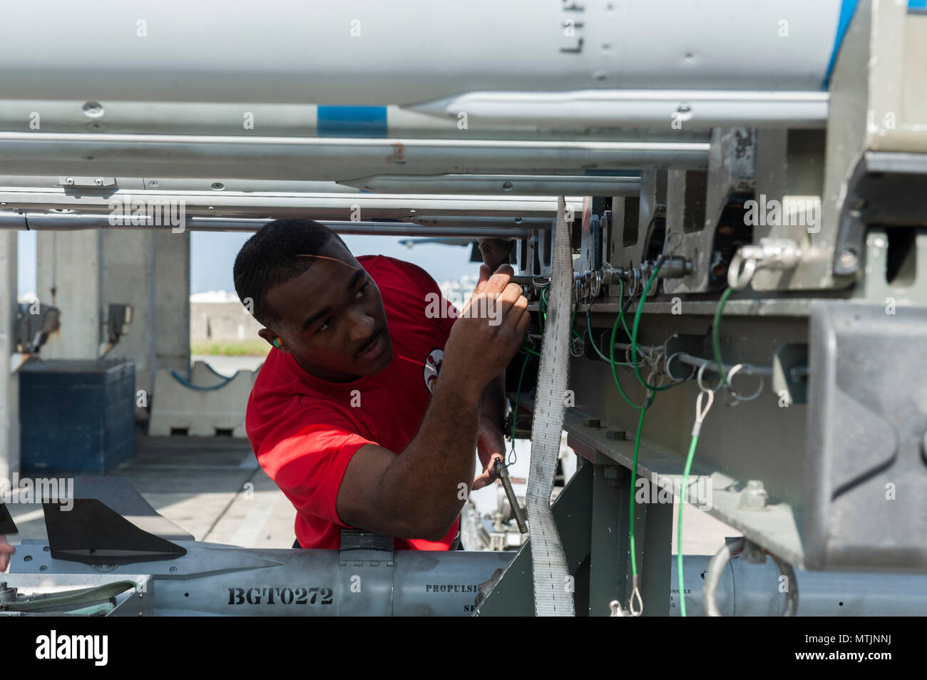 U.S. Air Force Senior Airman Andre Douglas prepares to load an AIM-120 ...