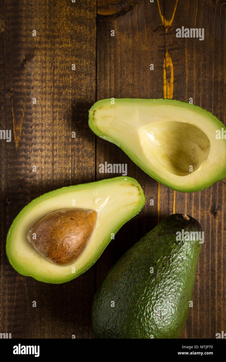 Fresh Avocado on Dark Wood Background. Healthy Food Concept Stock Photo ...