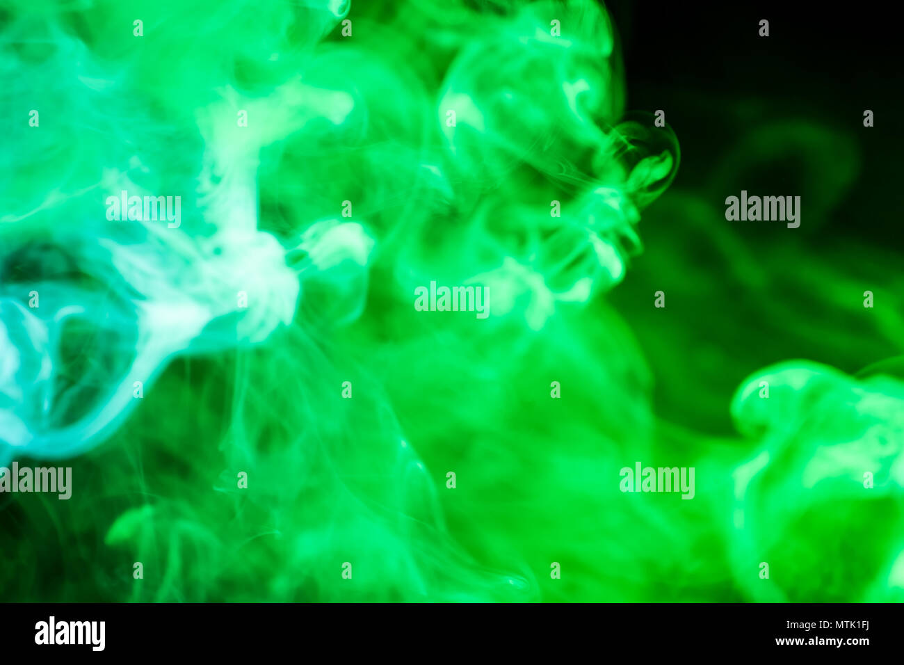 Dense green smoke on a black isolated background. Background of smoke ...