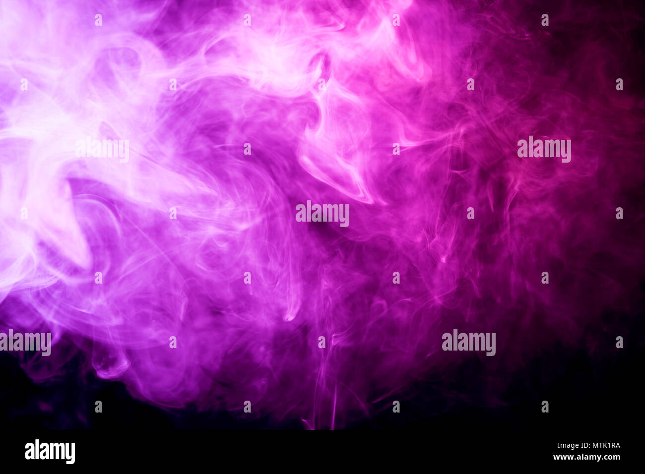 Thick pink smoke on a black isolated background. Background from the ...