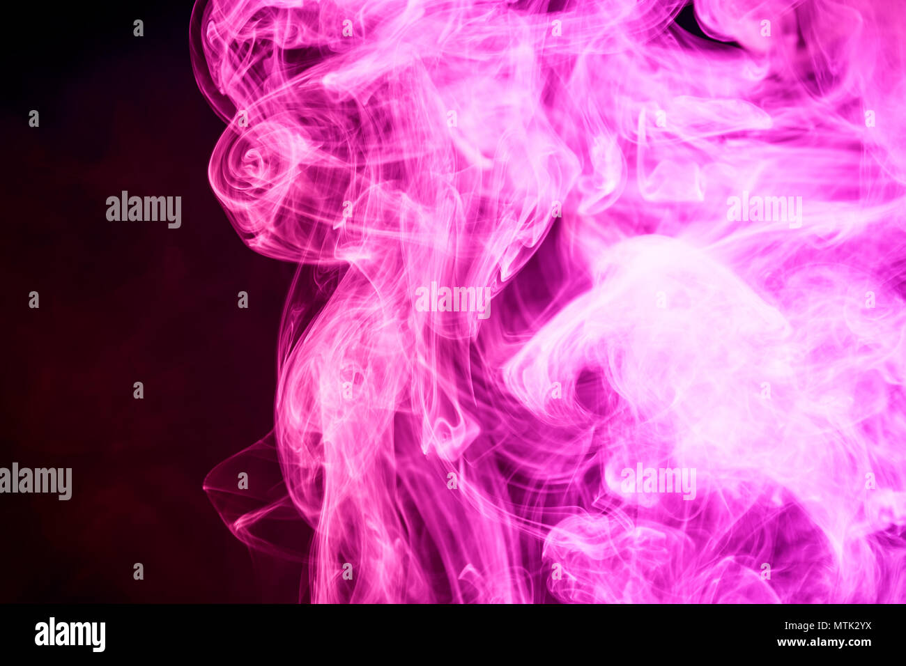 Cloud of pink smoke on a black isolated background. Background from the ...