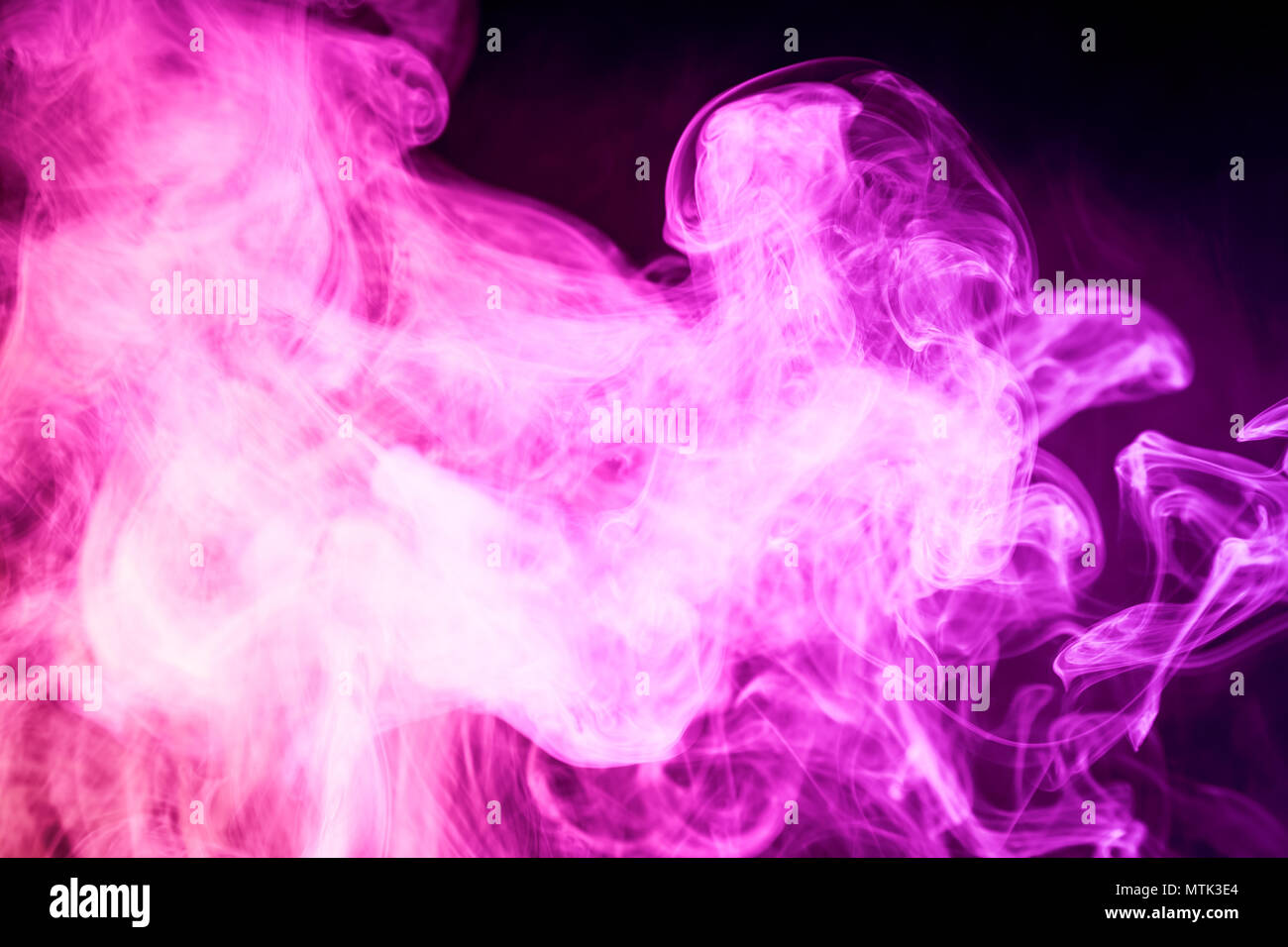 Cloud of pink smoke on a black isolated background. Background from the ...