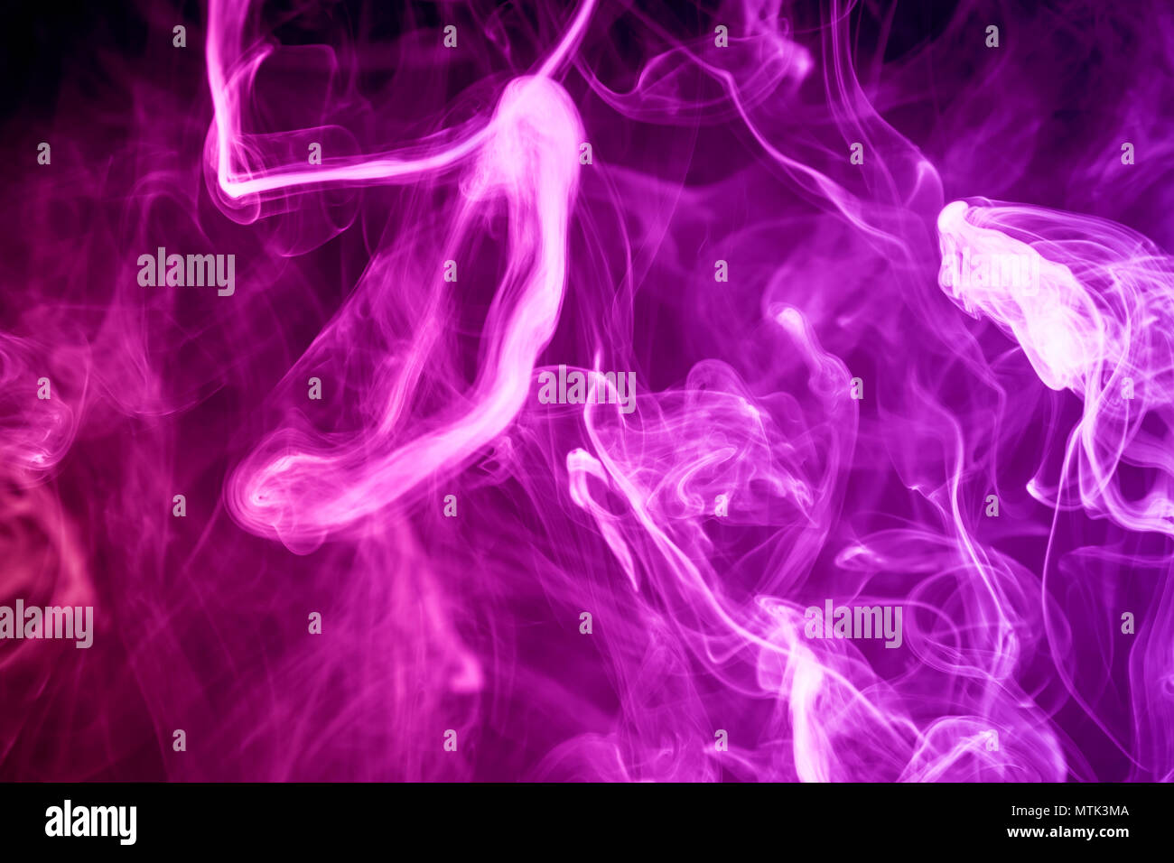 Cloud of pink smoke on a black isolated background. Background from the ...