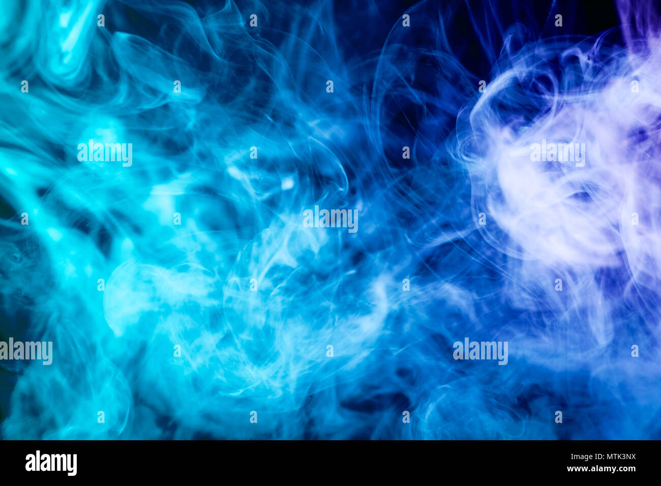Thick colorful blue smoke on a black isolated background. Background ...