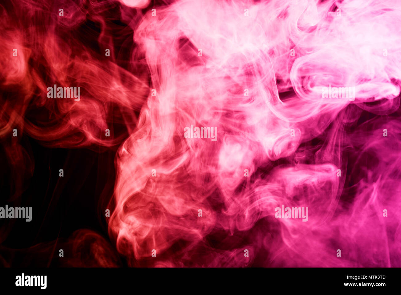 Thick colorful red smoke on a black isolated background. Background ...