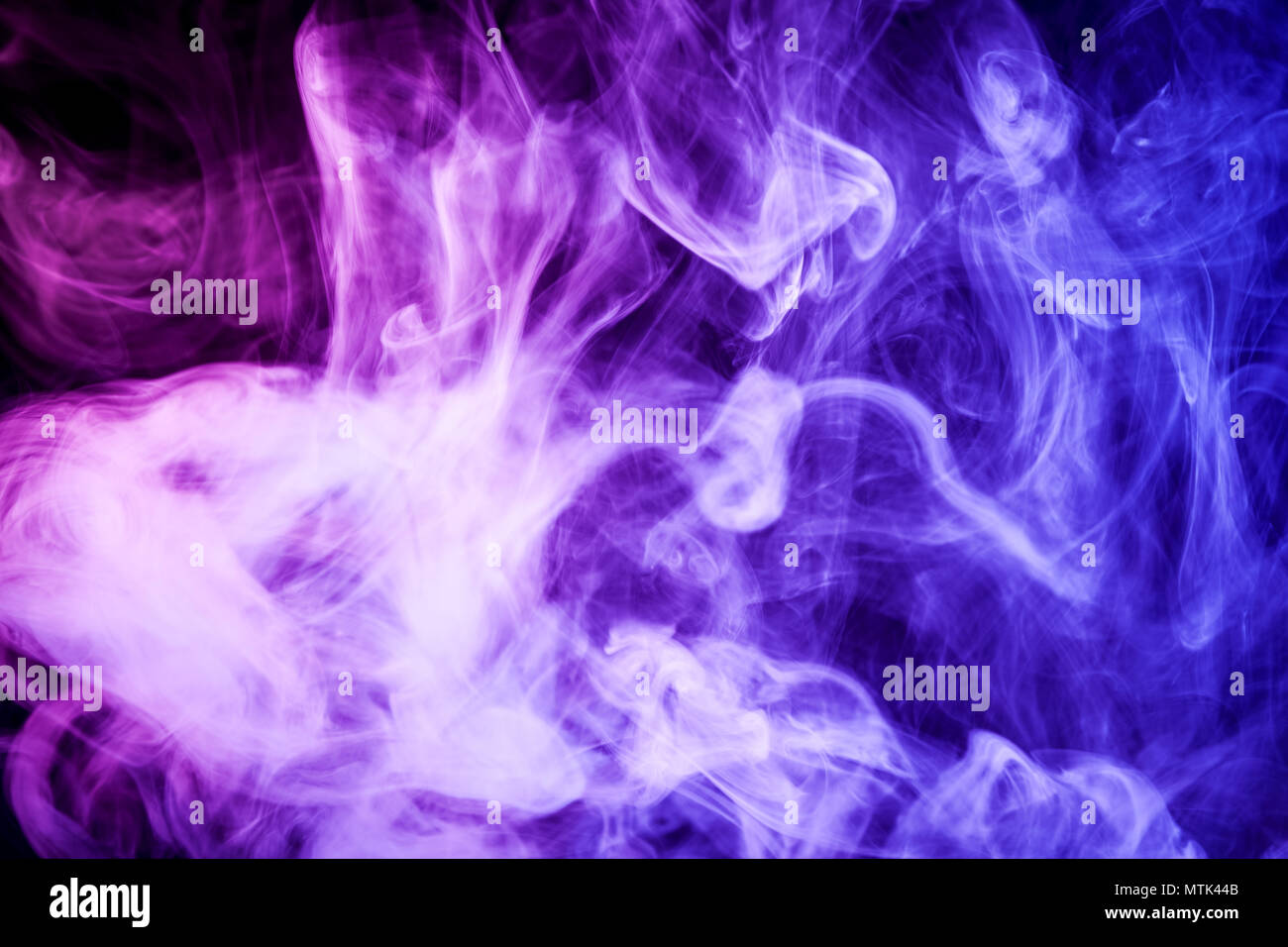 Colorful purple smoke on a black isolated background. Background from ...