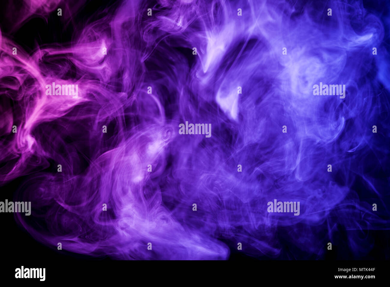 Colorful purple smoke on a black isolated background. Background from ...